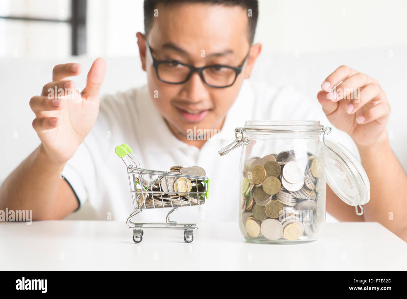 asian male saving money Stock Photo - Alamy