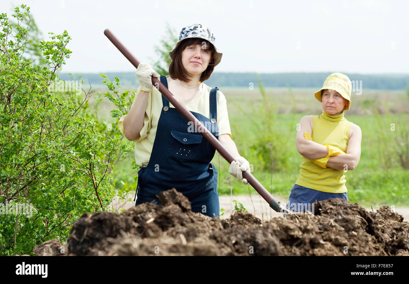 Female farmers works with manure at field Stock Photo - Alamy
