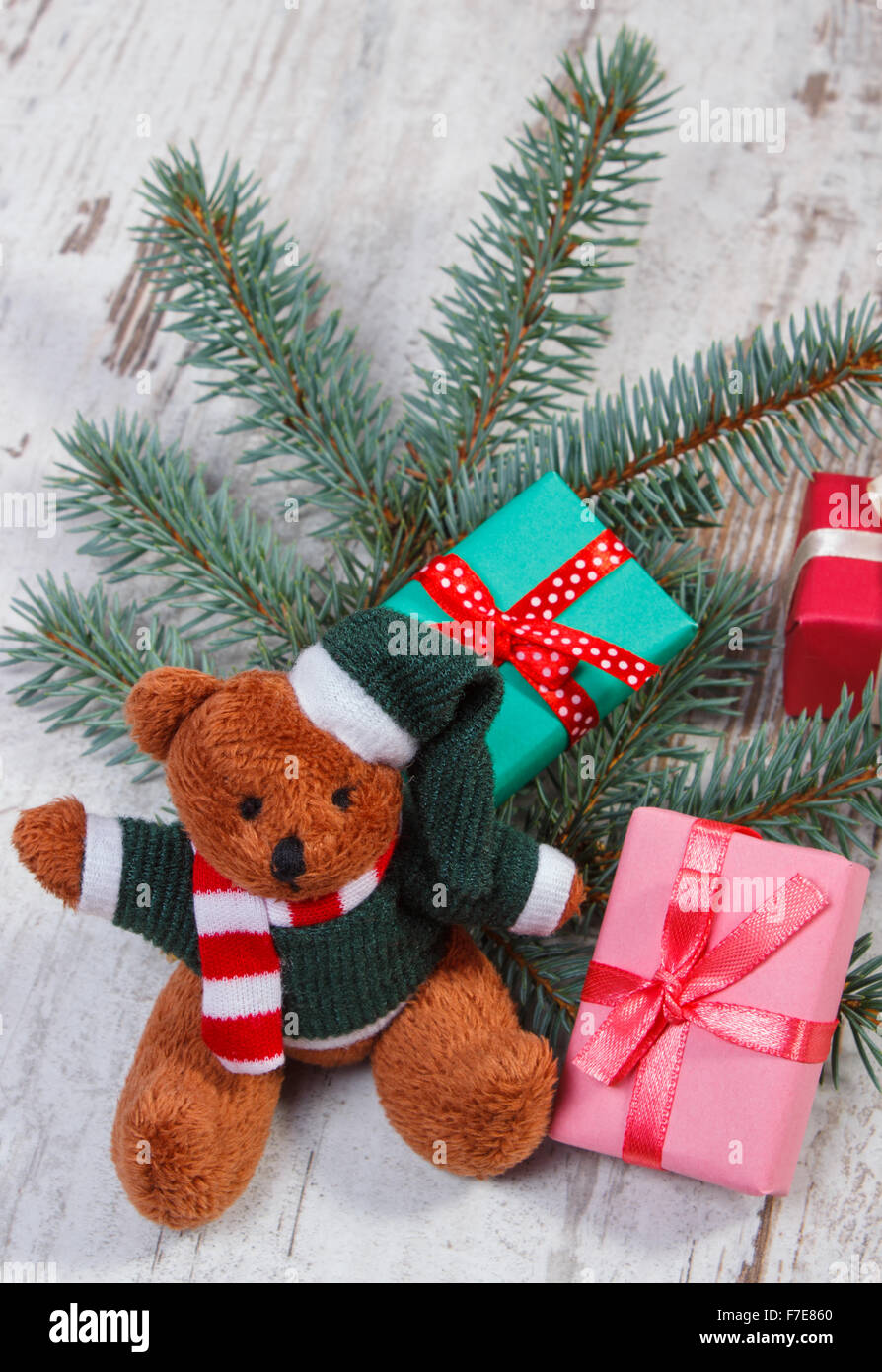 Fluffy teddy bear with wrapped colorful gifts for Christmas or other ...
