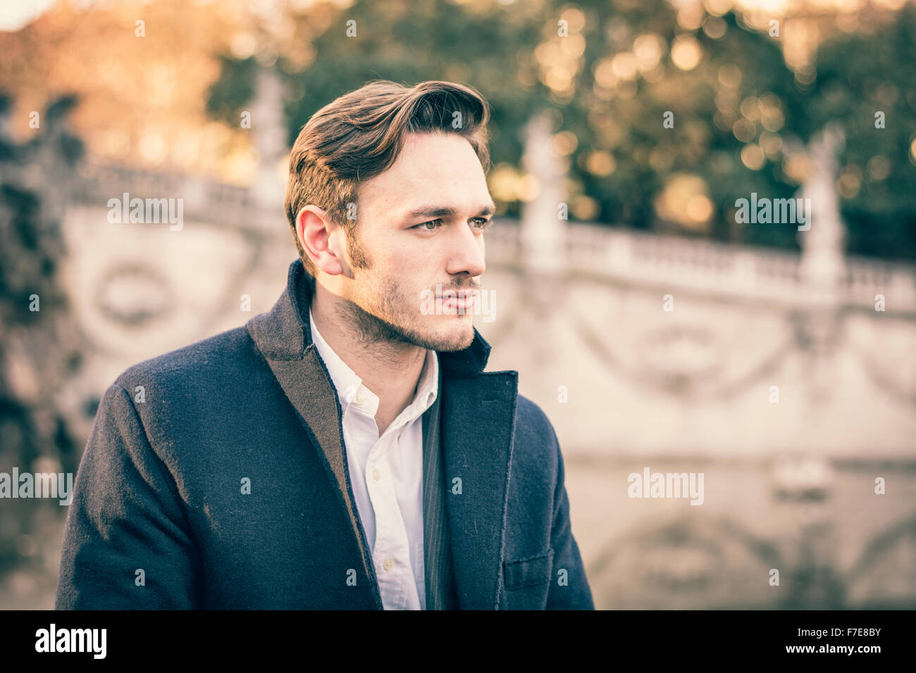 Handsome young man outdoor in winter fashion, wearing black coat and ...
