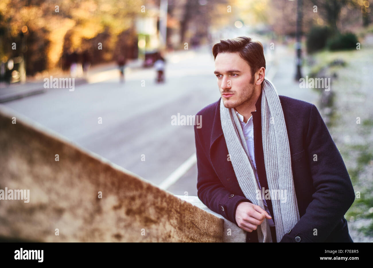 Handsome young man outdoor in winter fashion, wearing black coat and ...