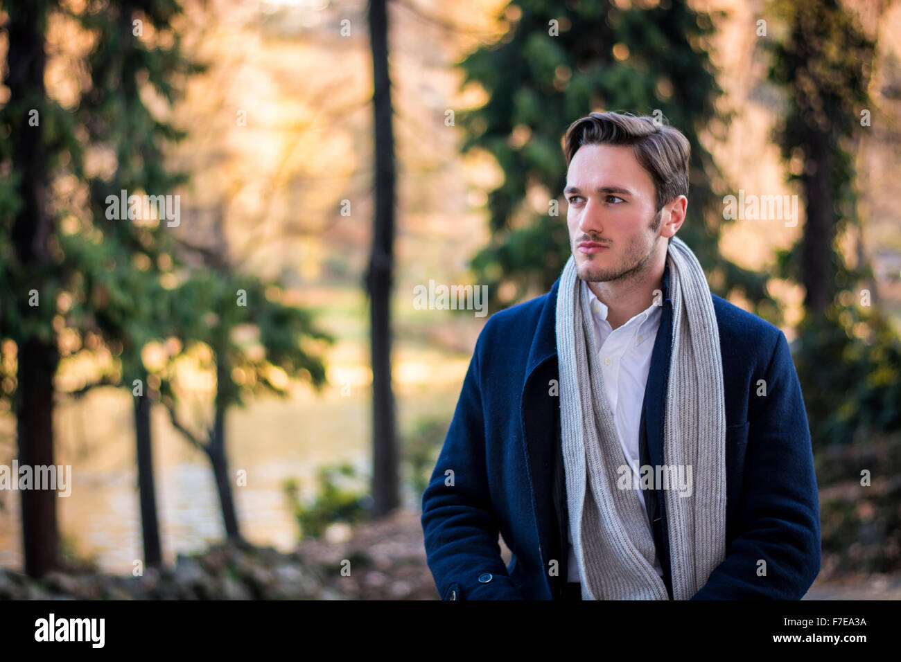 Handsome young man outdoor in winter fashion, wearing black coat and ...