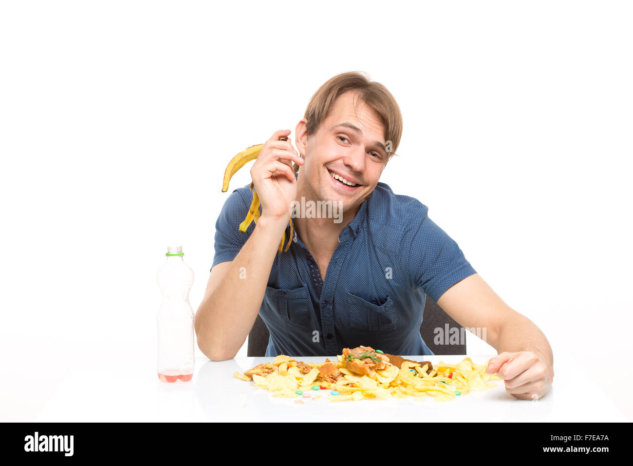 man eating a banana. on the table a lot of dirt and debris. isolated on ...