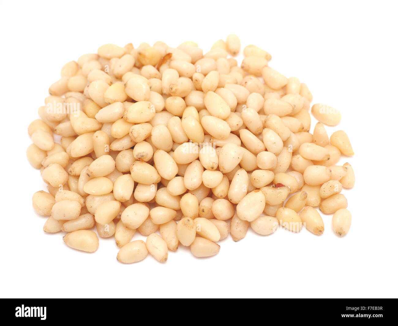 Peeled pine nuts on a white background Stock Photo - Alamy