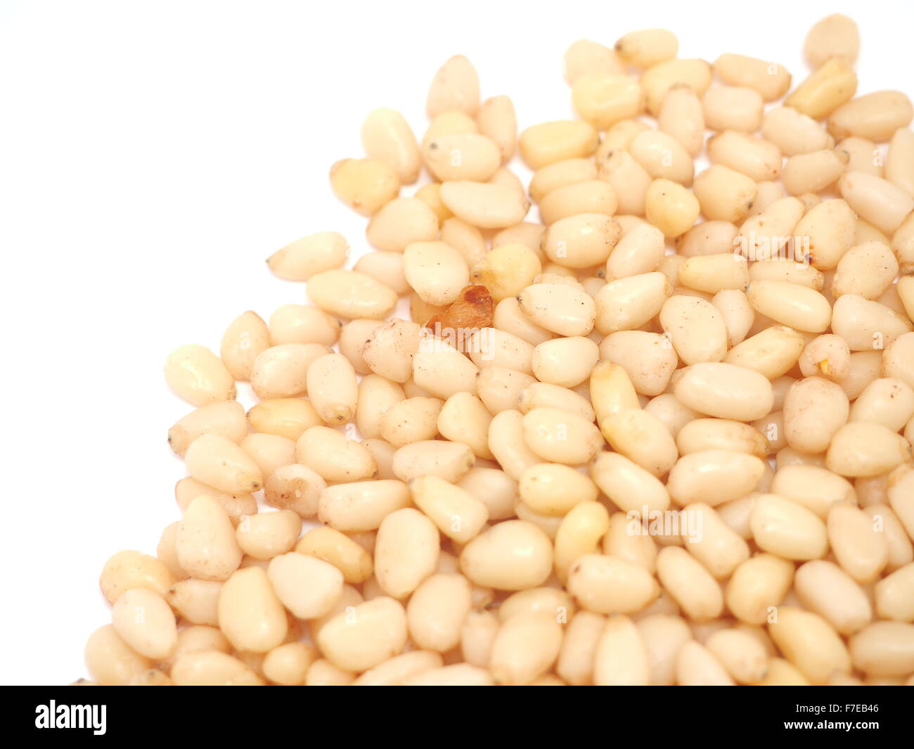 Peeled pine nuts on a white background Stock Photo - Alamy
