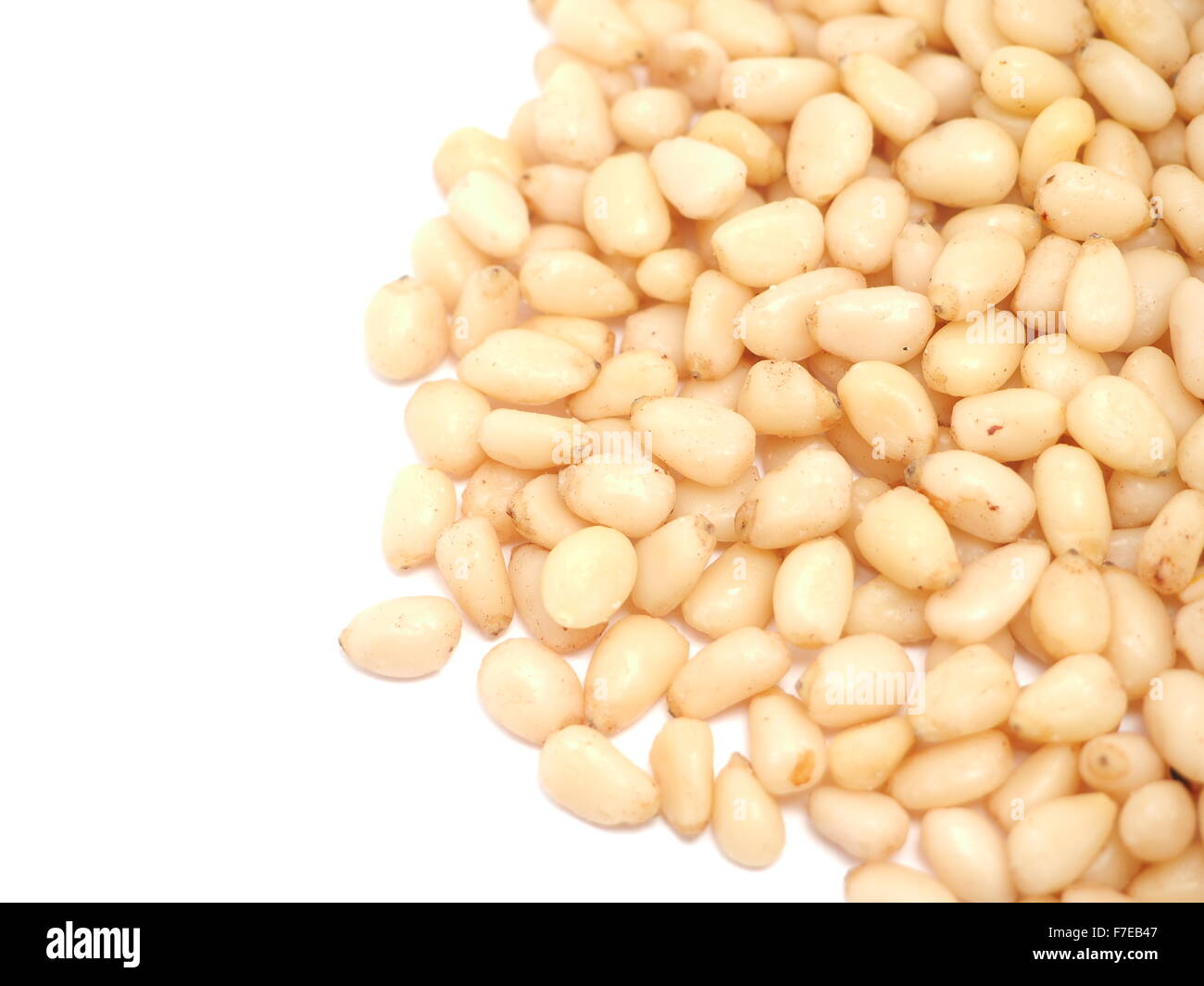 Peeled pine nuts on a white background Stock Photo - Alamy