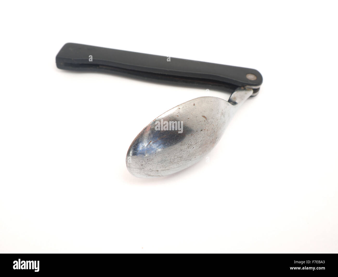 Folding travel spoon on a white background Stock Photo - Alamy