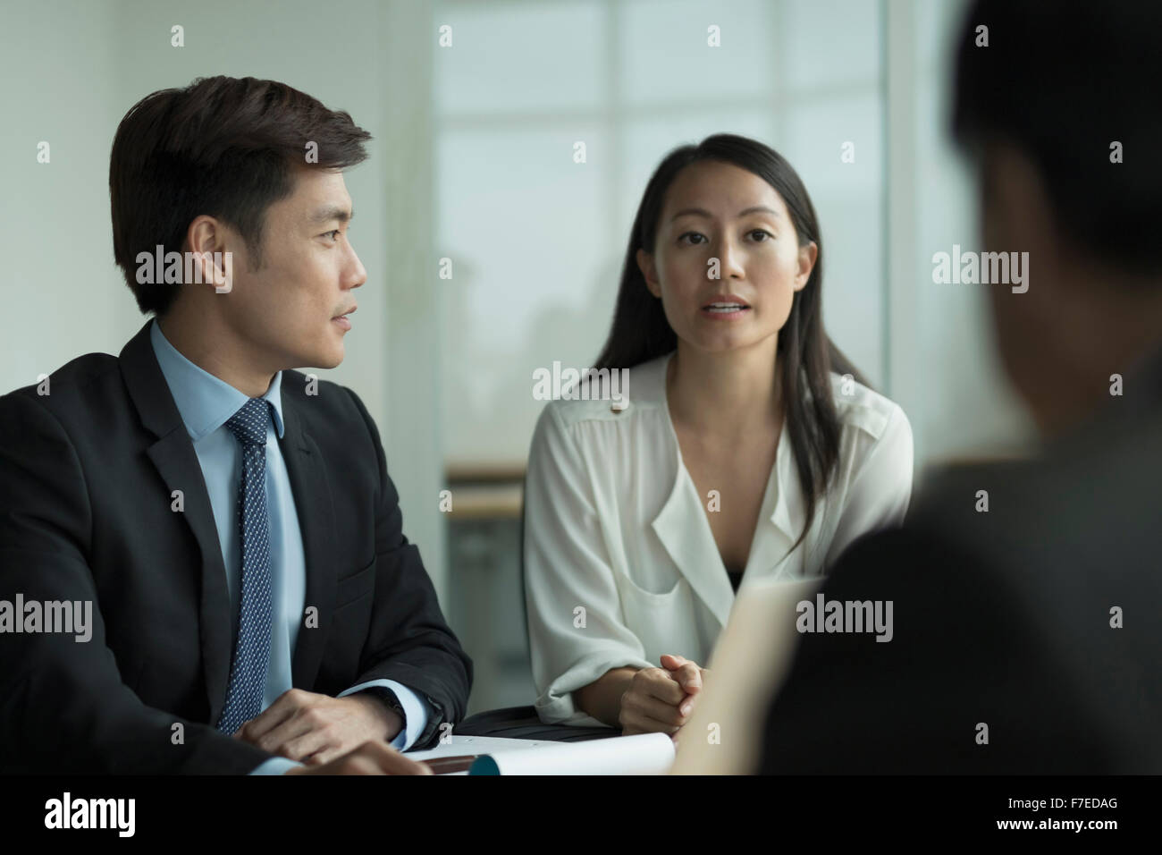 Singapore, Three business people talking at desk Stock Photo - Alamy