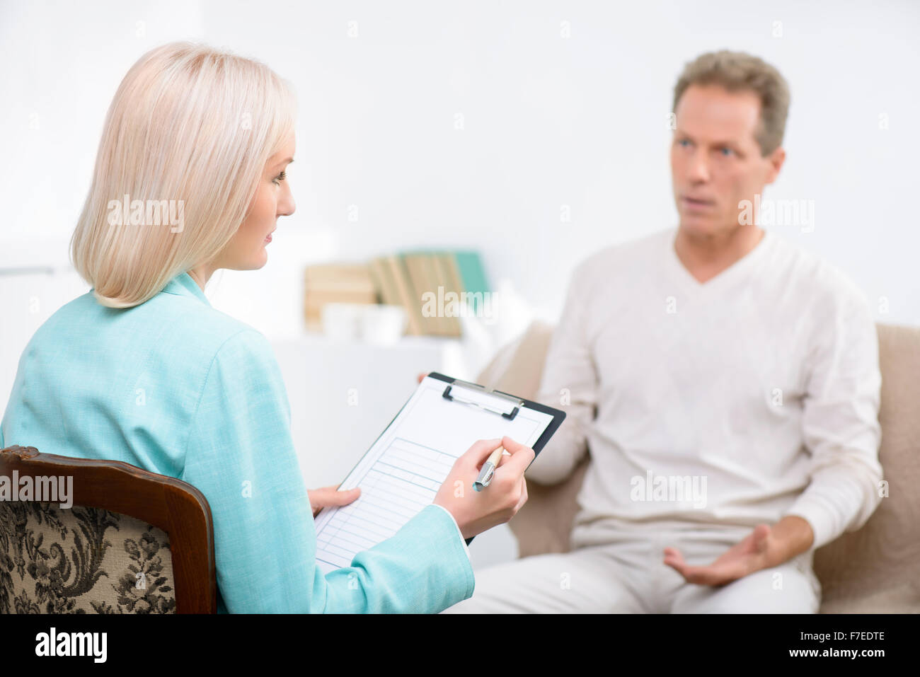 Senior man speaking with psychologist Stock Photo - Alamy