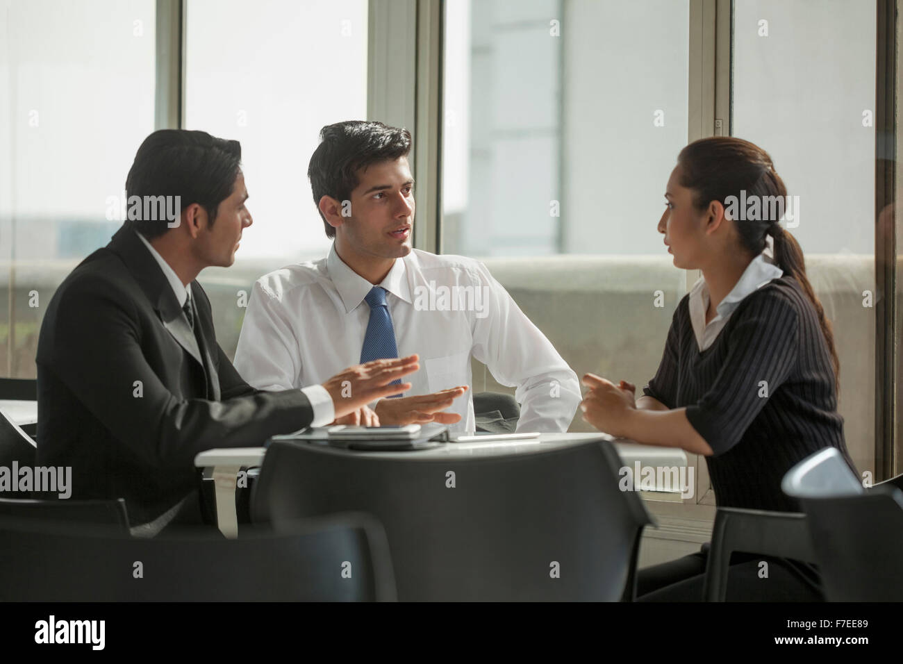 India, Three colleagues having discussion in office Stock Photo - Alamy