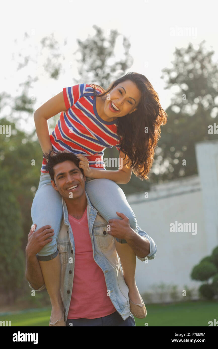 India, Man carrying woman on shoulders on sunny day Stock Photo - Alamy