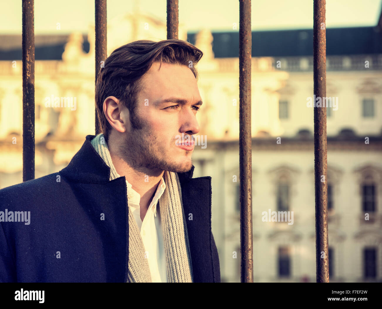 Handsome young man outdoor in winter fashion, wearing black coat and ...