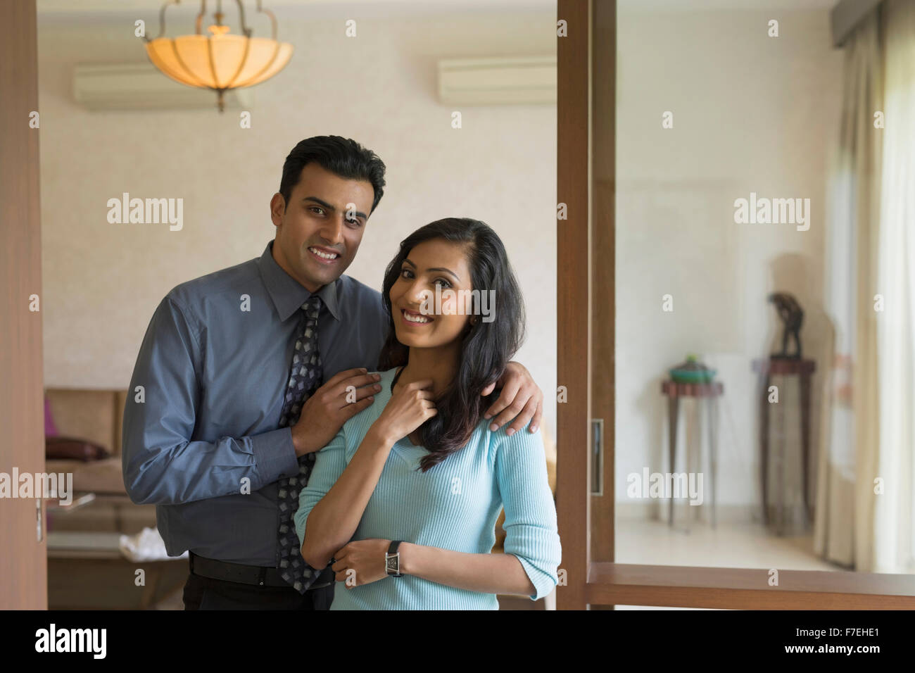 Man embracing woman and smiling at camera Stock Photo - Alamy