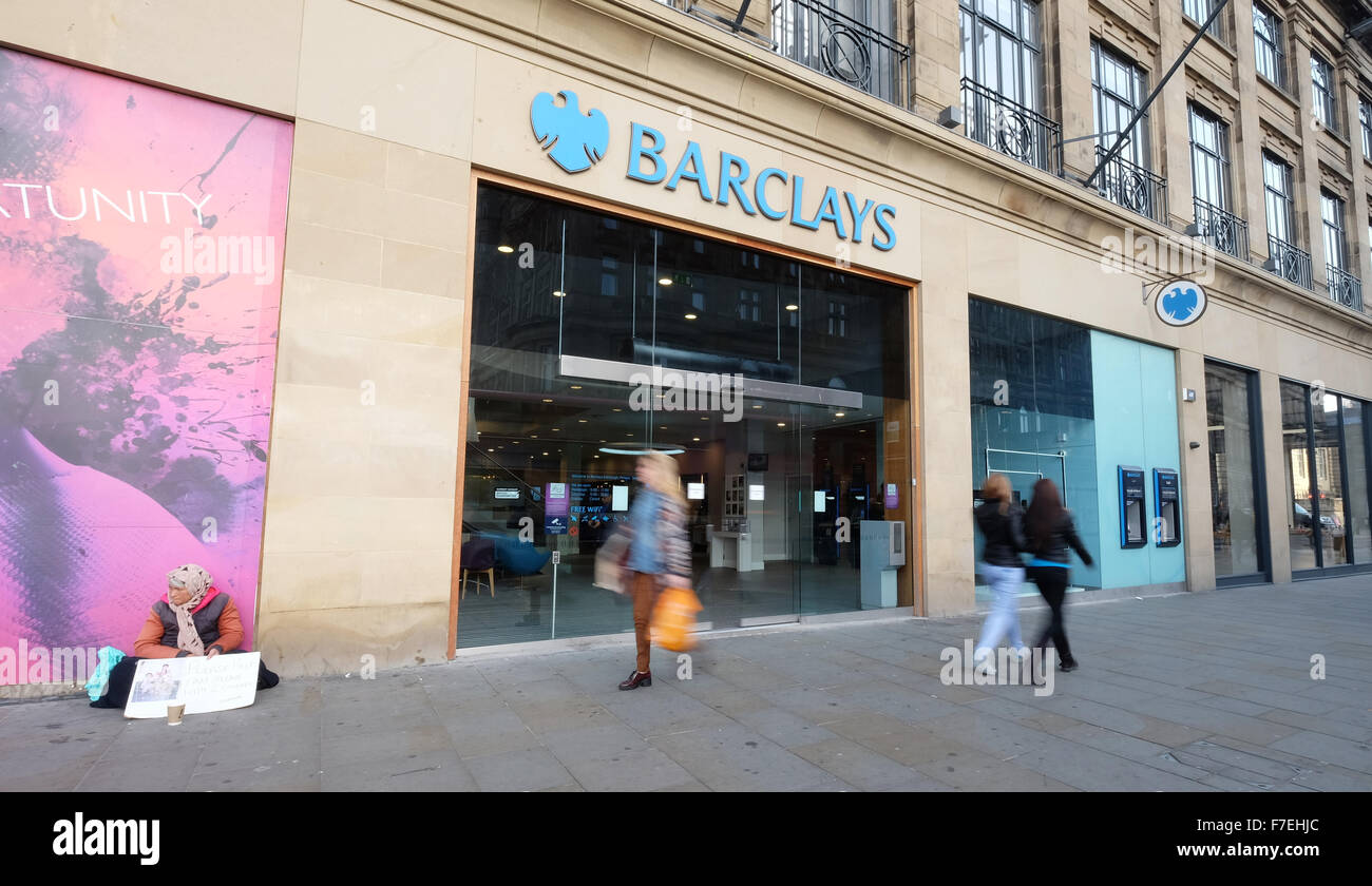 An Eastern Eurpoean beggar sits outside the Barclays bank branch on ...