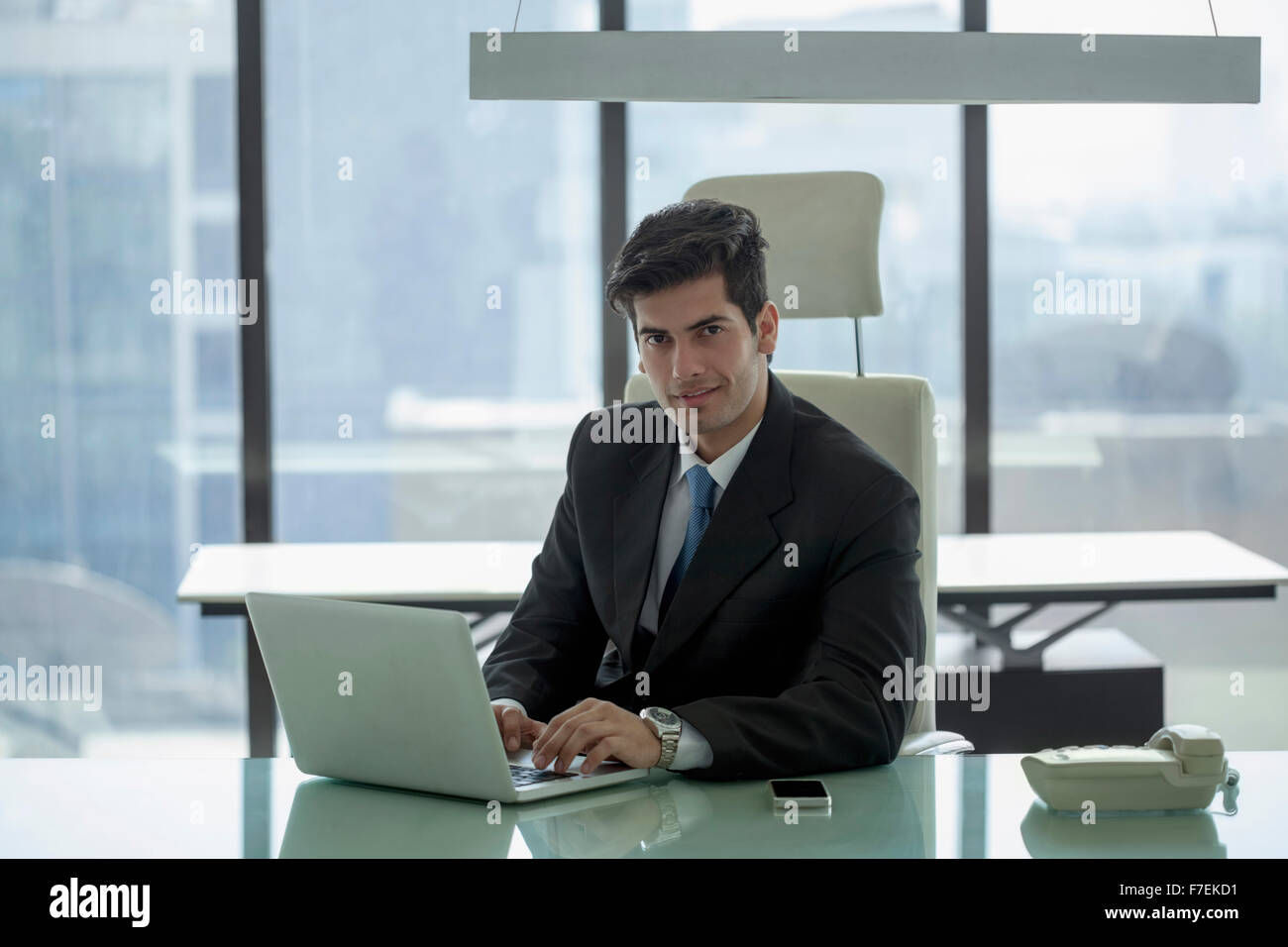 Businessman at desk looking up from over hi-res stock photography and ...