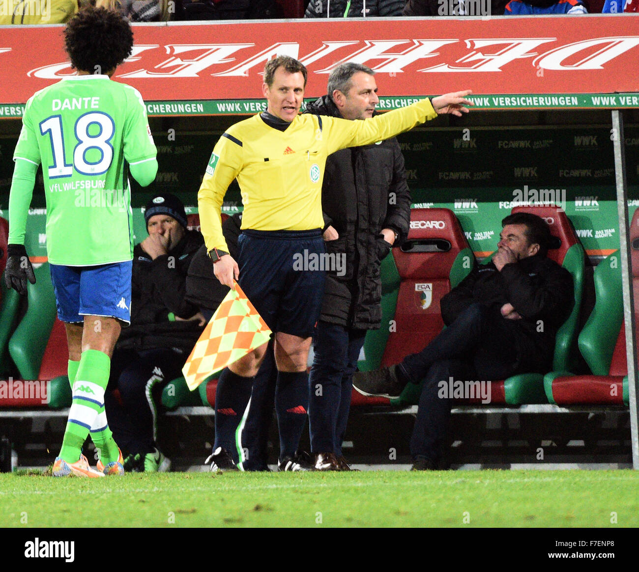 Line referee Tobiuas Christ (2nd L) gestures to Wolfsburg's Dante (L ...