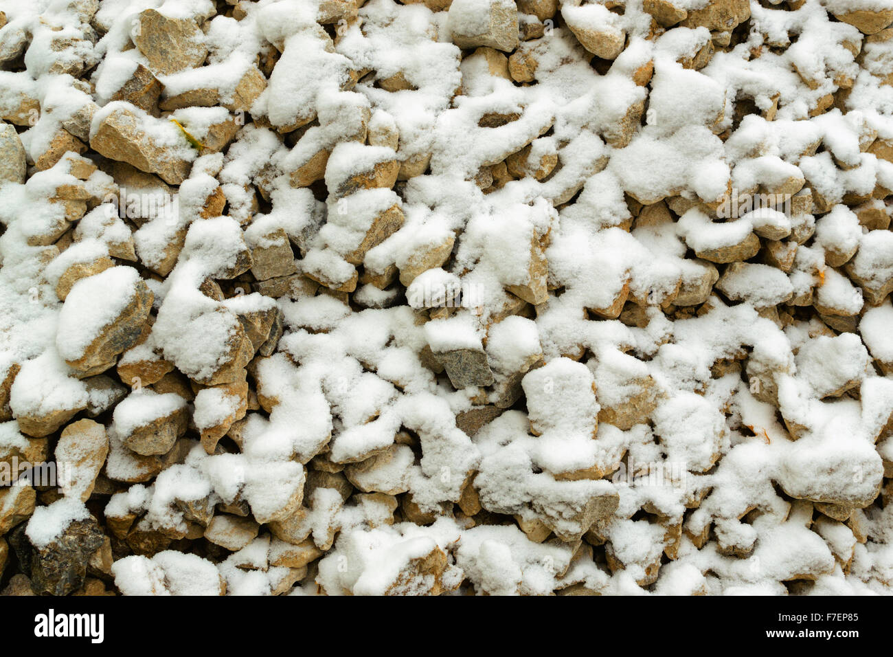 Fresh light snow falls onto many stones, suggesting a travel on ...