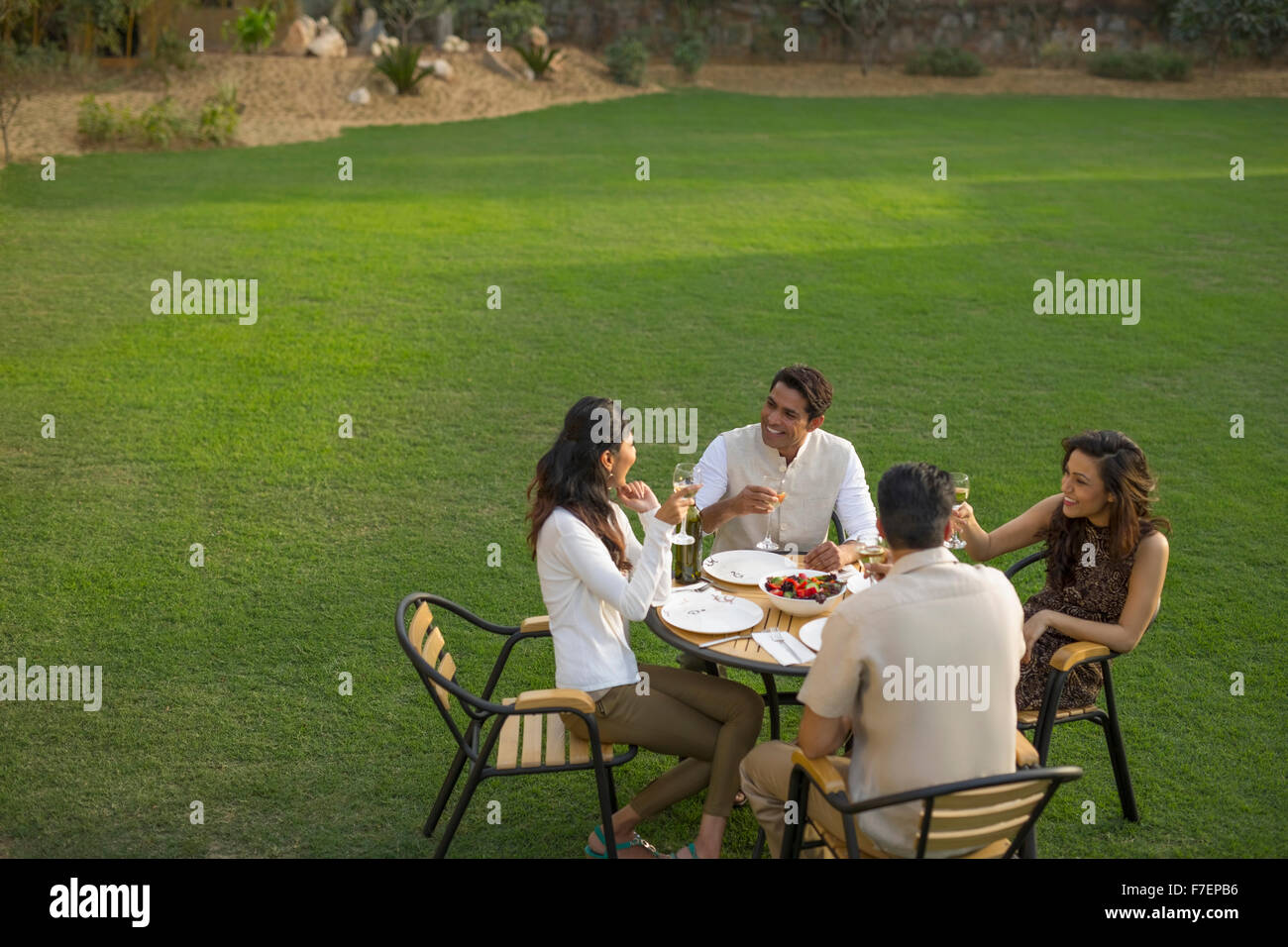 Four friends dining outside Stock Photo - Alamy