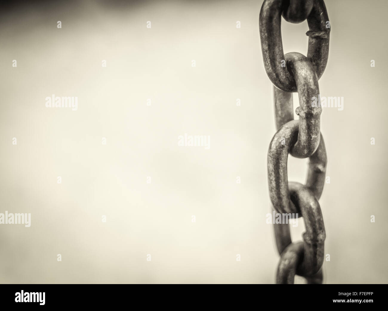 Single chain hanging in a vertical position with a white grunge style ...