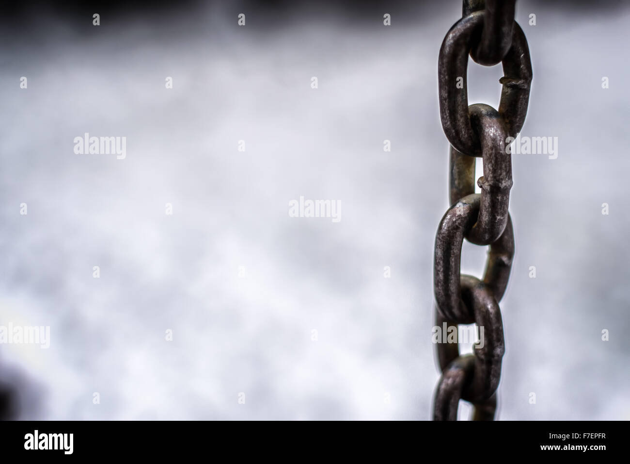 Single chain in black and white monochrome hanging in a vertical ...