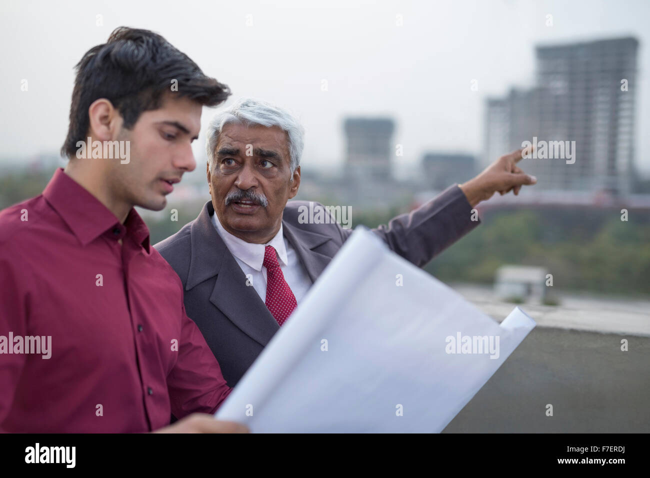 India, Architects and client discussing building plans Stock Photo - Alamy