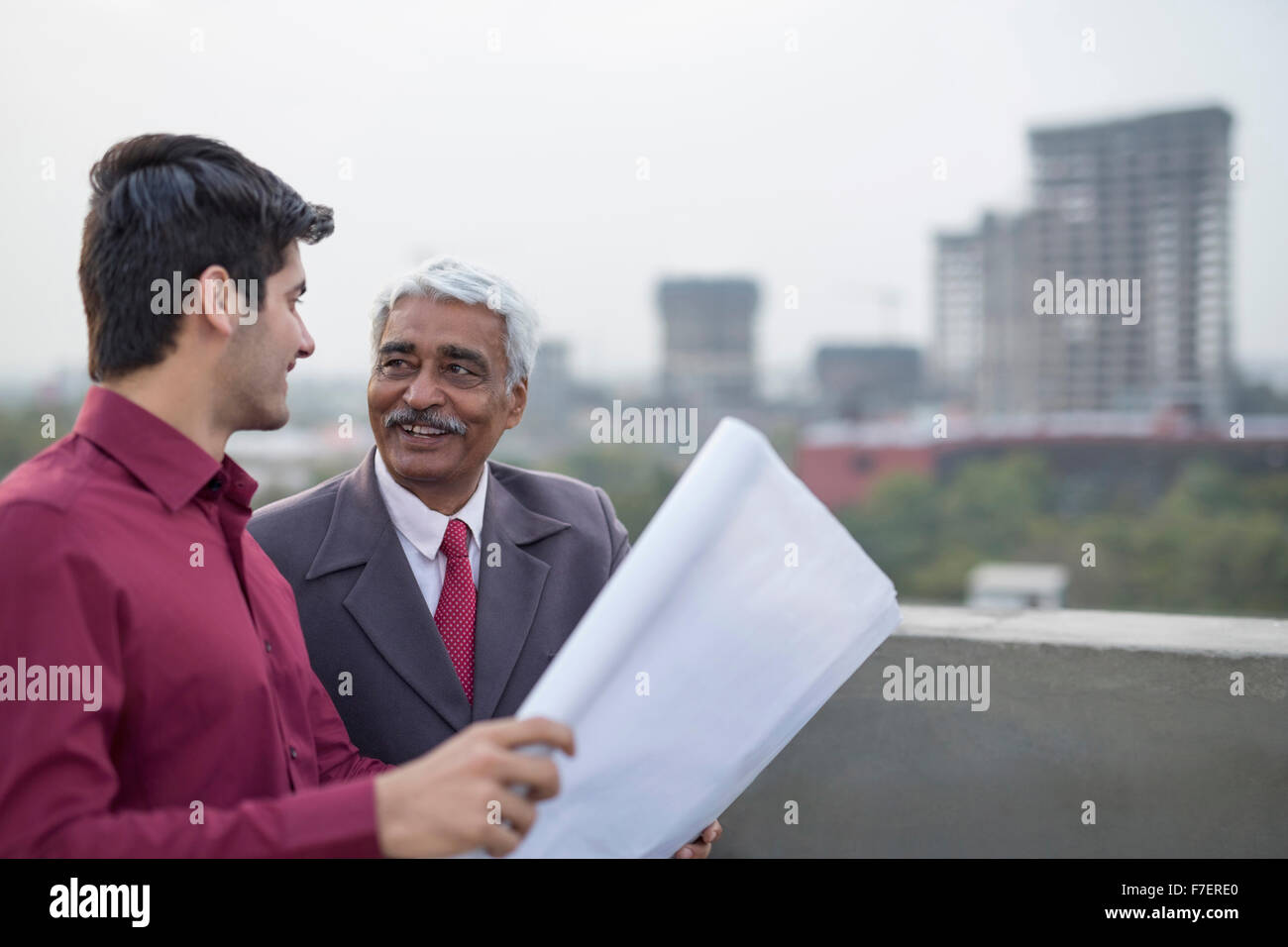 India, Architects and client discussing building plans Stock Photo - Alamy