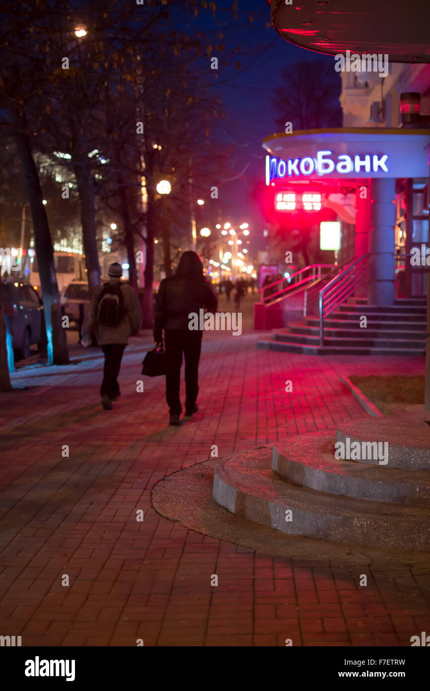 People walking on a illuminated city street in Ufa, Russia in October ...
