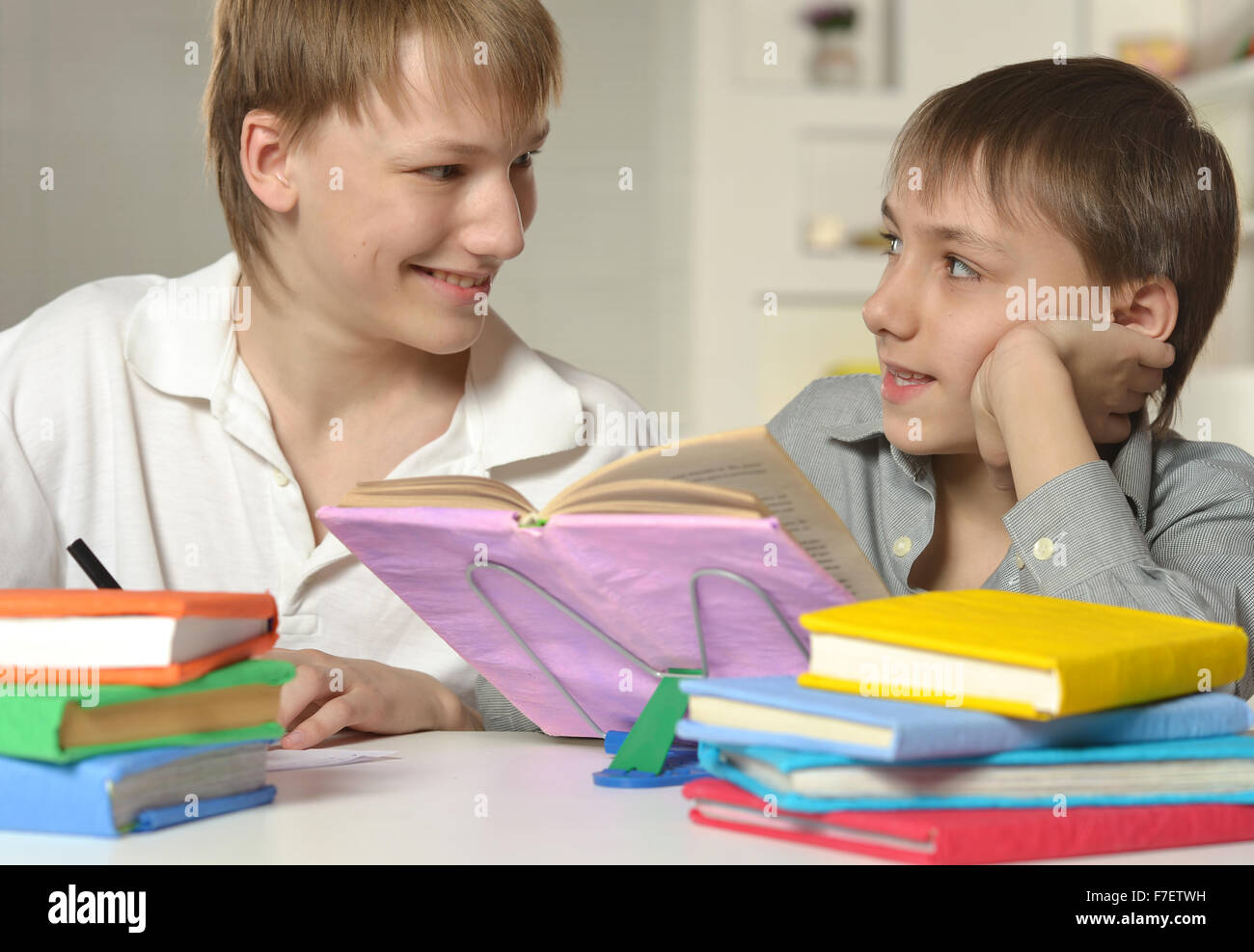 Two brothers doing homework at home at table Stock Photo - Alamy