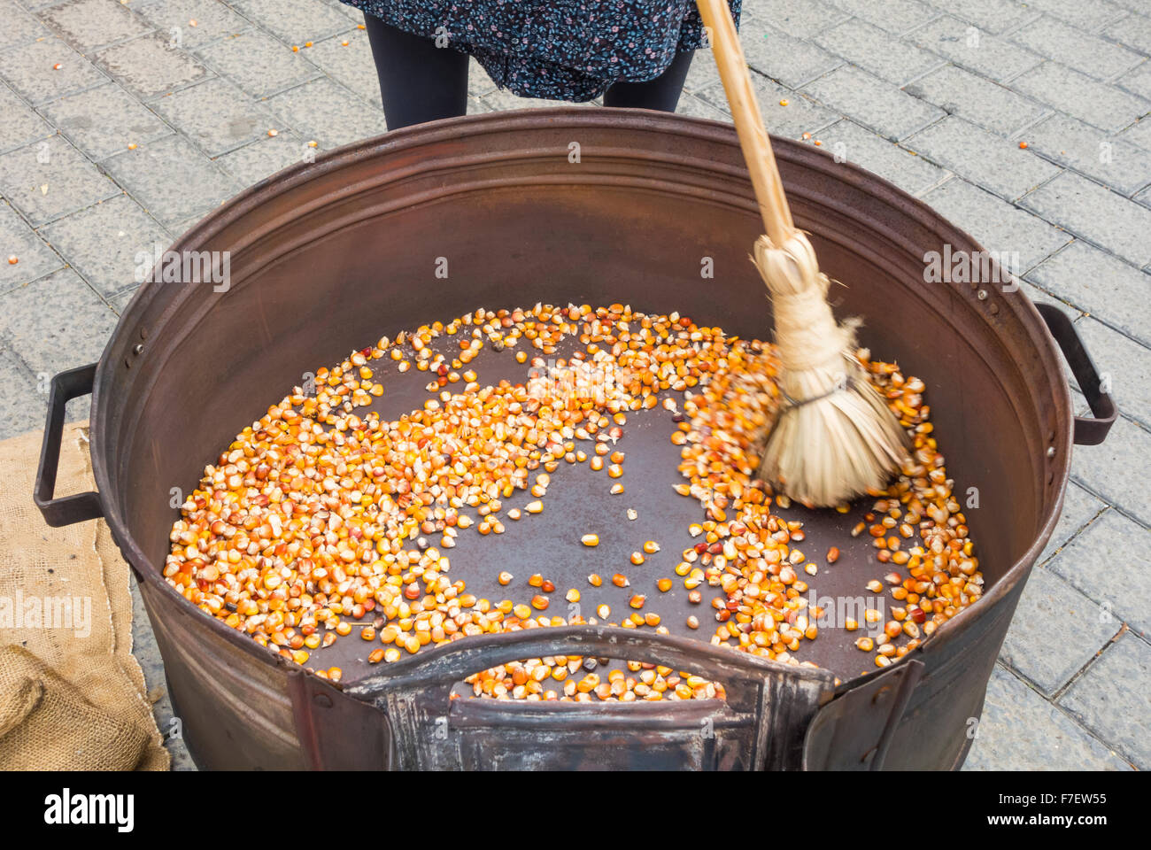 Elderly lady toasting corn the traditional way in La Aldea village ...