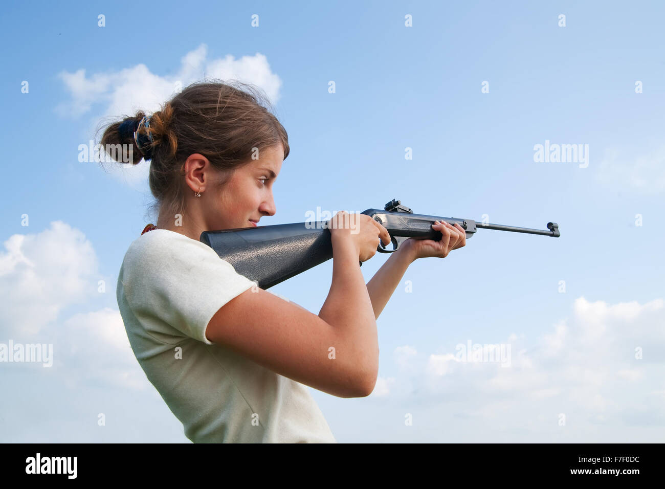 young woman aiming a pneumatic air rifle Stock Photo - Alamy