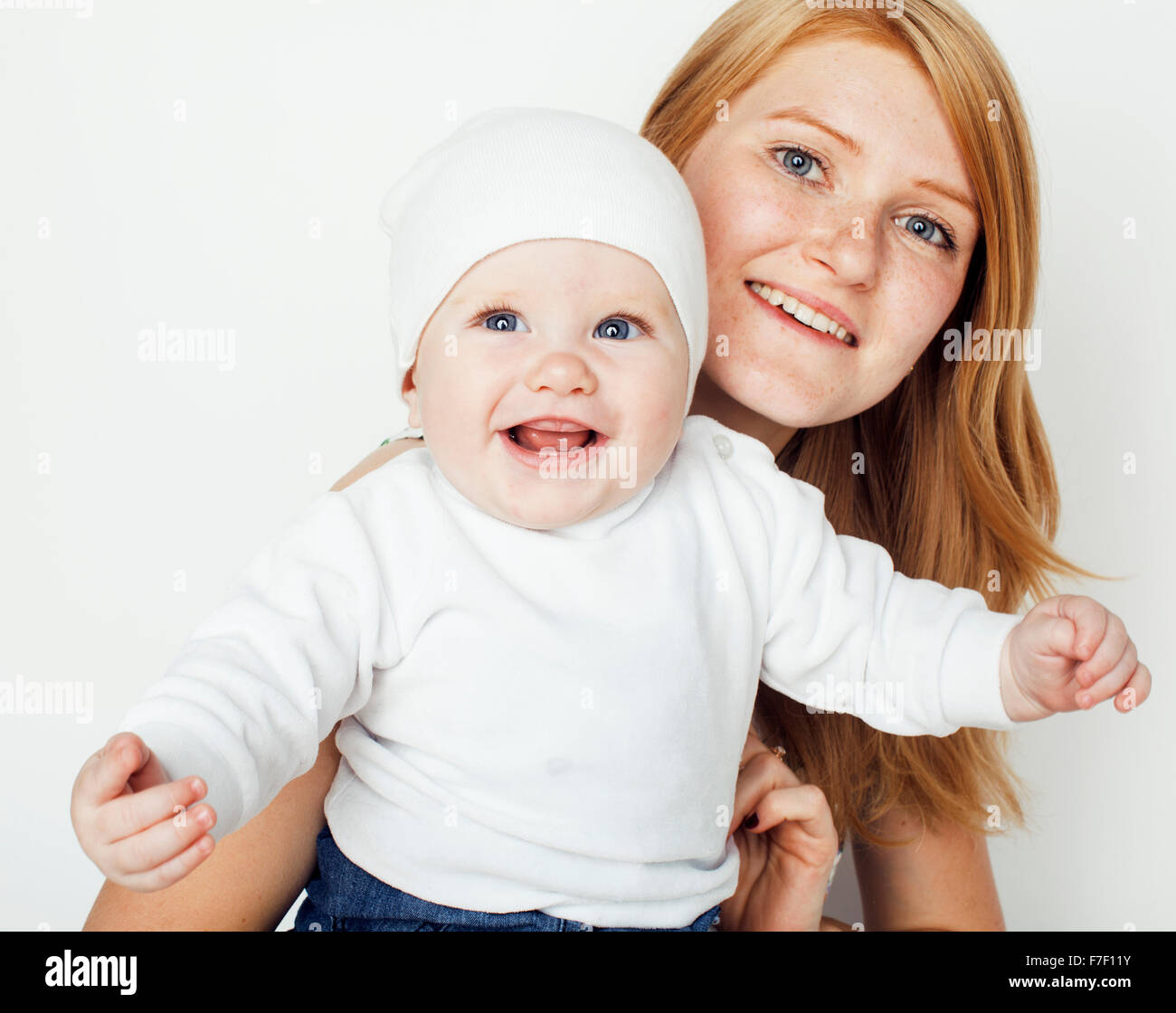 young beauty mother with baby, red head happy family isolated Stock ...