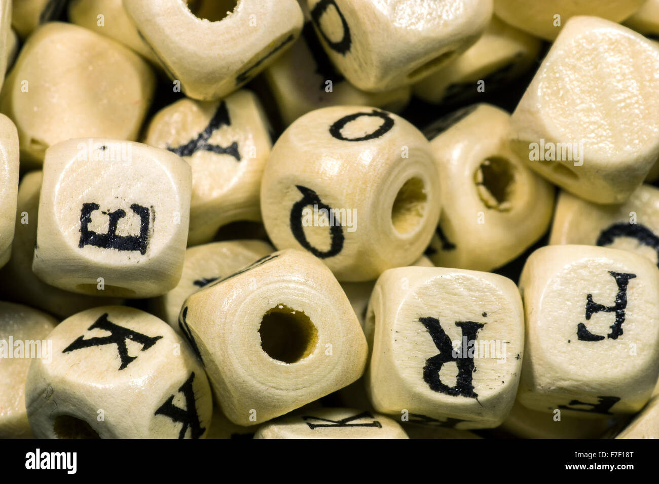 Macro close-up of many hand painted handicraft alphabet wooden beads ...