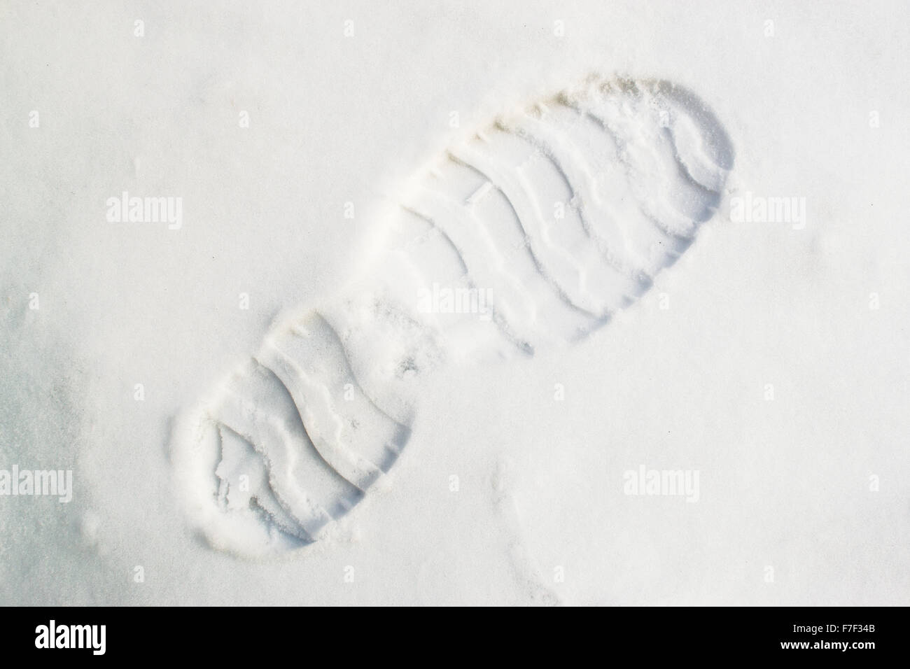Single human bootprint in a diagonal composition in fresh crisp white ...