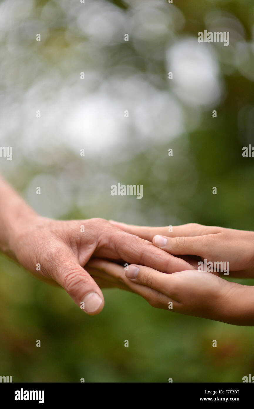Two hands together against Stock Photo - Alamy