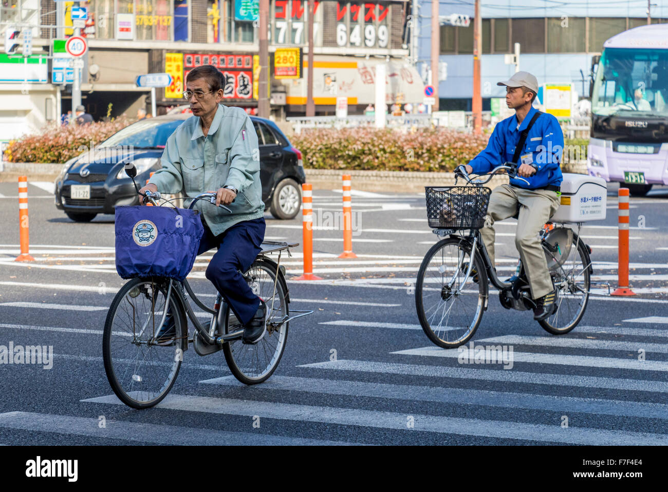Cyclist across major road in city of Osaka Japan Stock Photo - Alamy