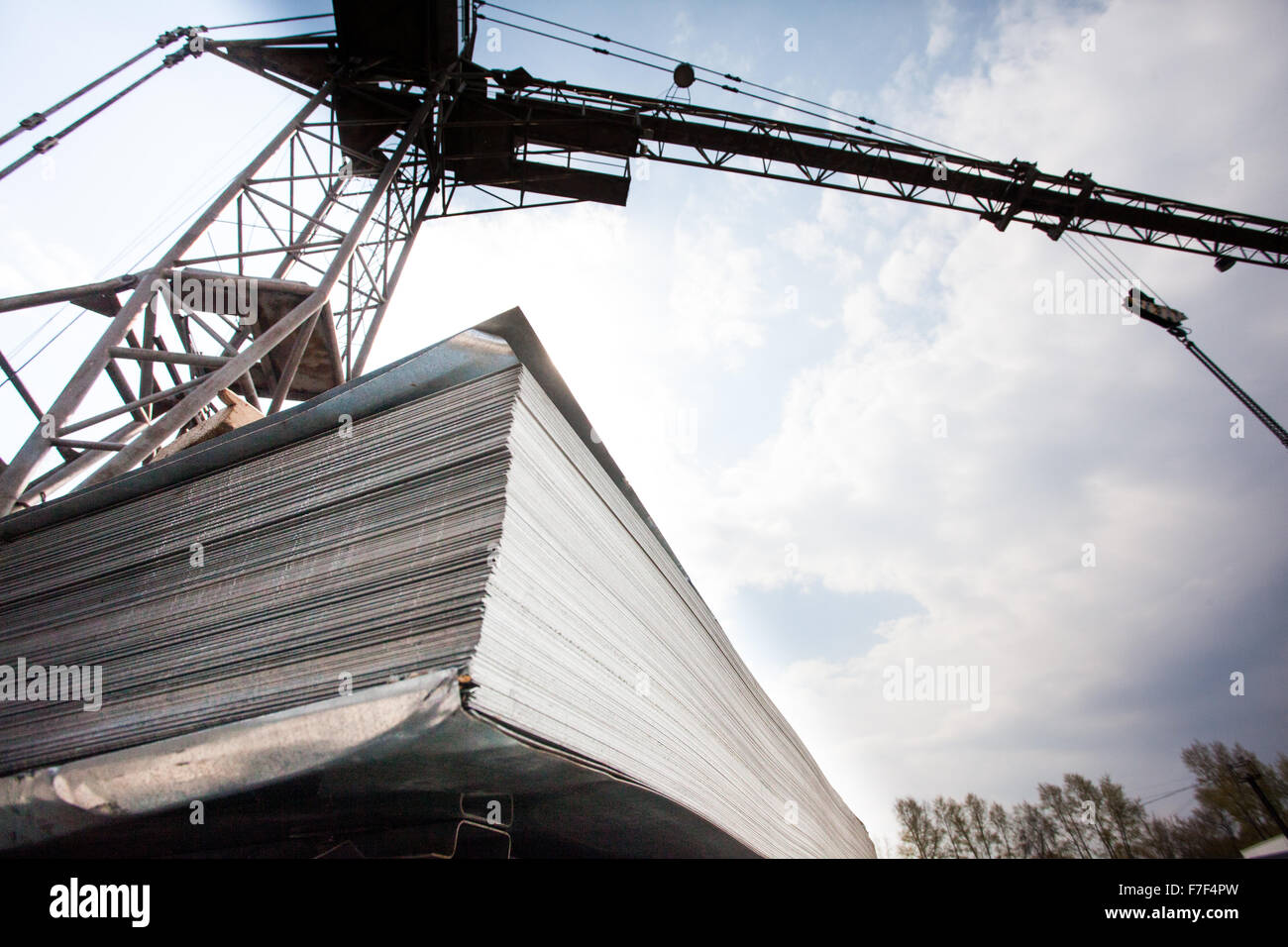 Crane and stack of steel plates Stock Photo - Alamy