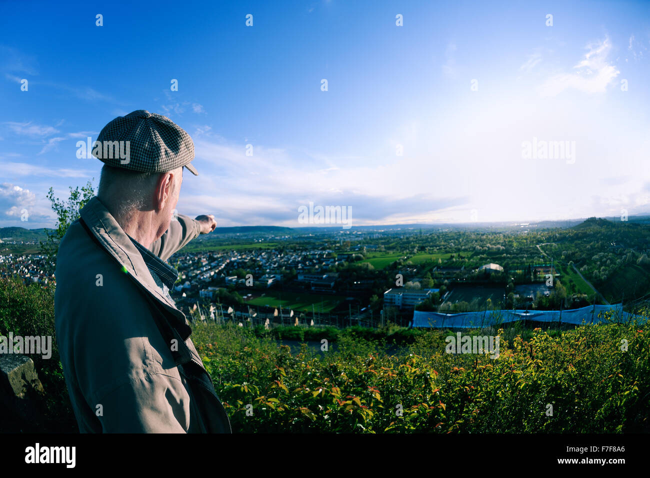 elderly man showing direction to sunset in nature Stock Photo - Alamy