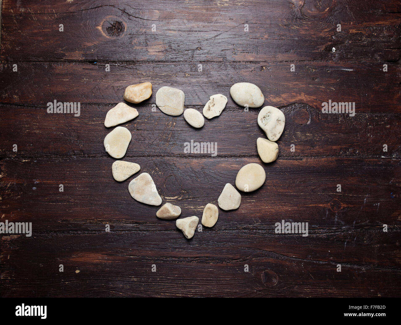 A heart shaped pebble stones on a old wood planks Stock Photo - Alamy