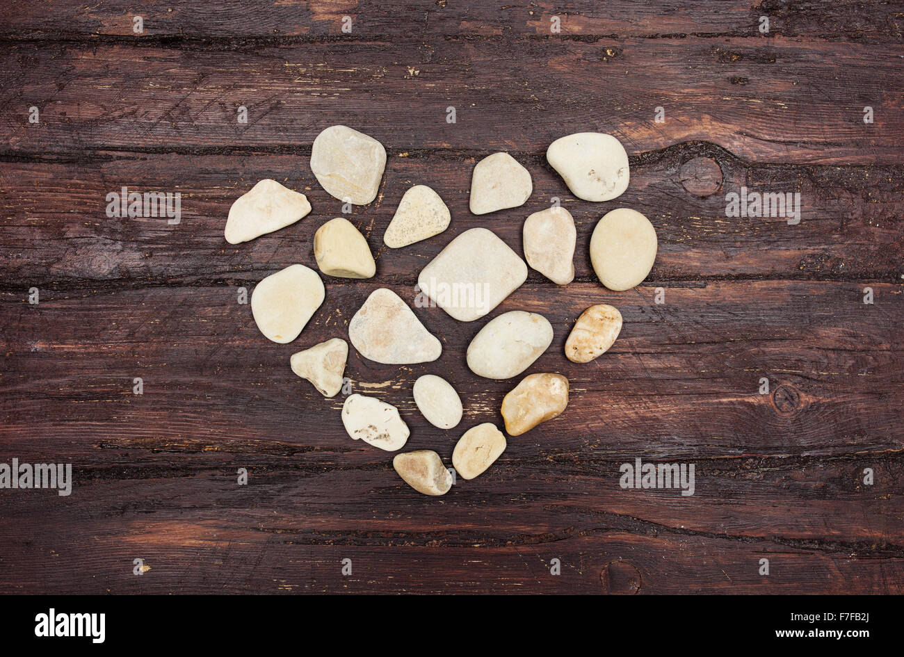 A heart shaped pebble stones on a old wood planks Stock Photo - Alamy