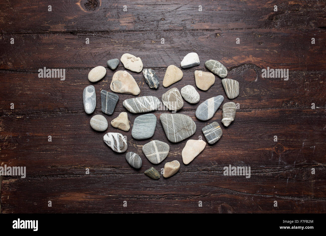 A heart shaped pebble stones on a old wood planks Stock Photo - Alamy