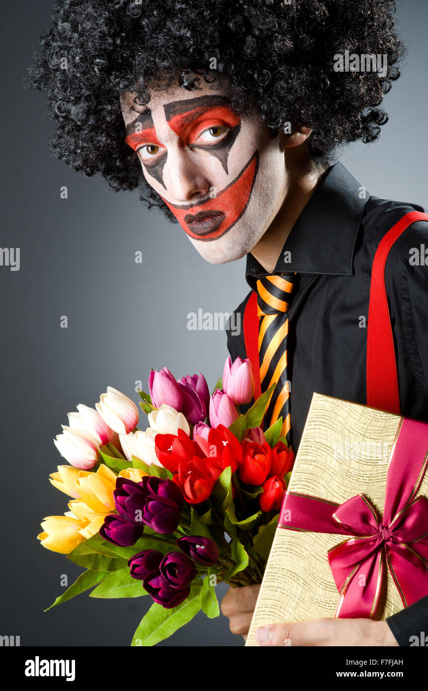 Sad clown with the flowers Stock Photo - Alamy