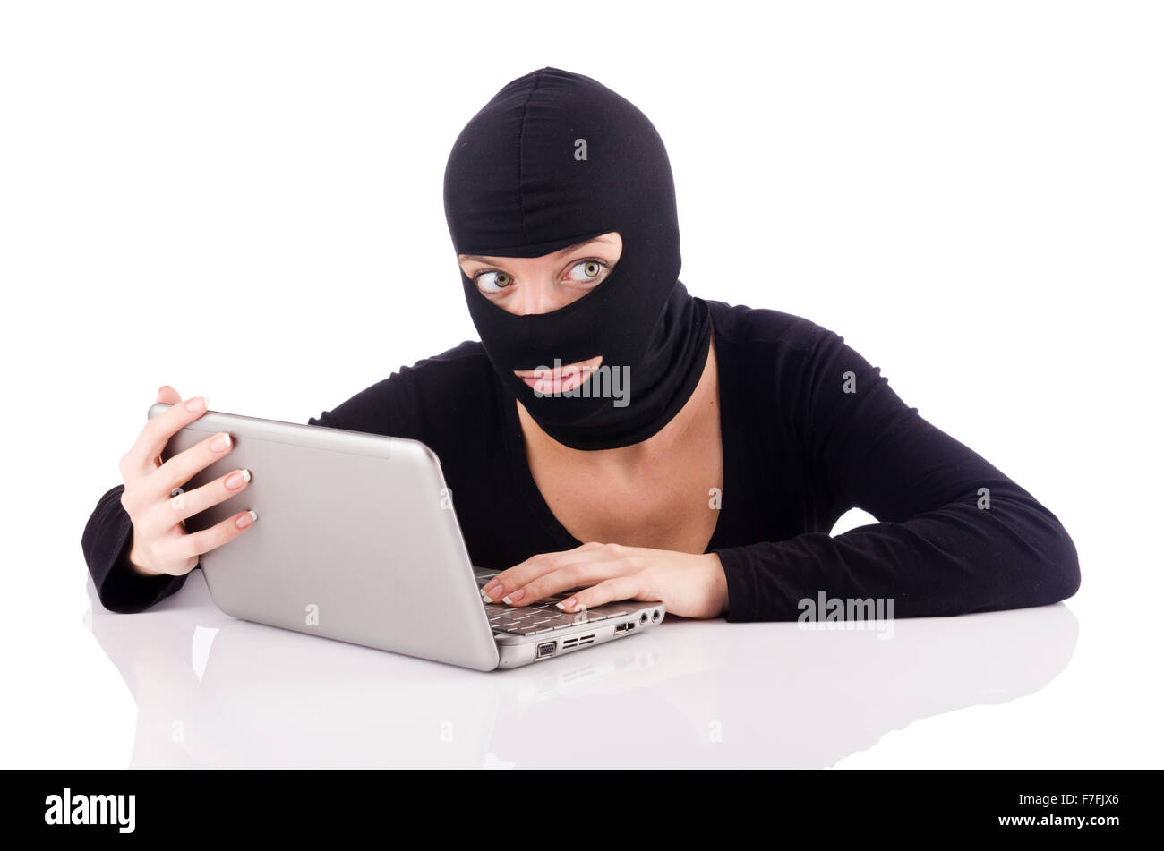 Hacker with computer wearing balaclava Stock Photo - Alamy