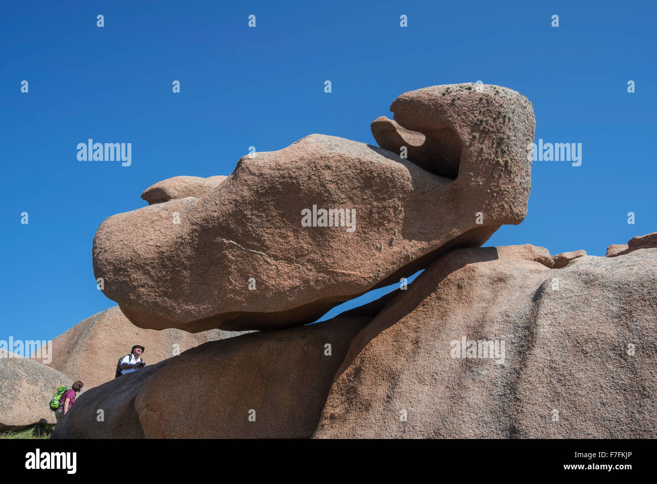 Tourists visiting strange rock formations along the Côte de granit rose ...