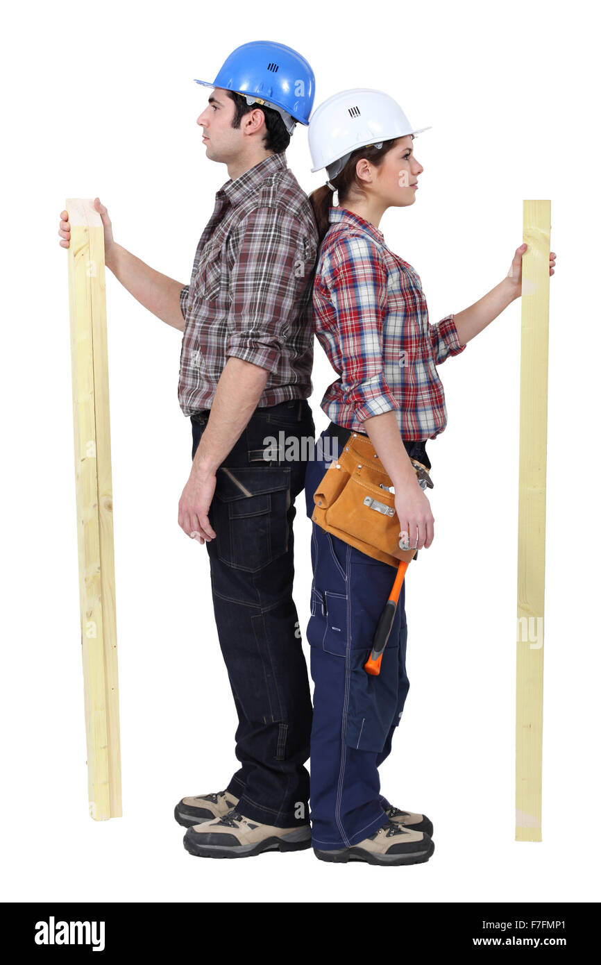 male and female carpenters standing back to back Stock Photo - Alamy