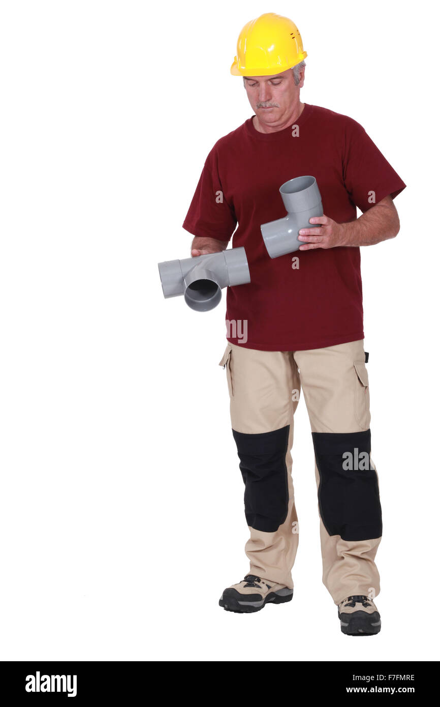 Plumber fitting two plastic pipes together Stock Photo - Alamy