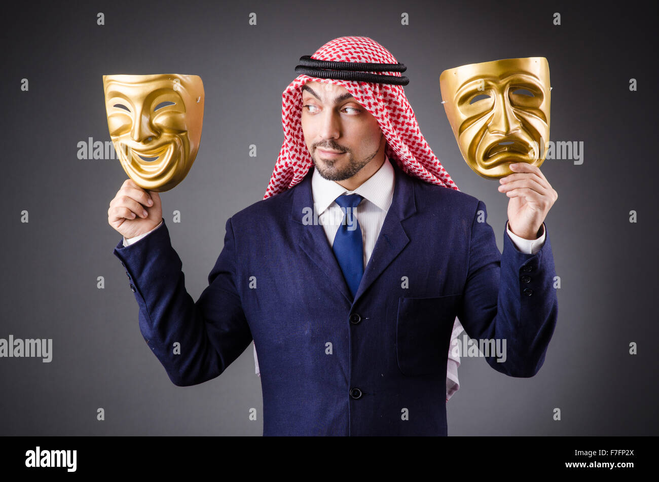 Arab with masks in dark studio Stock Photo - Alamy