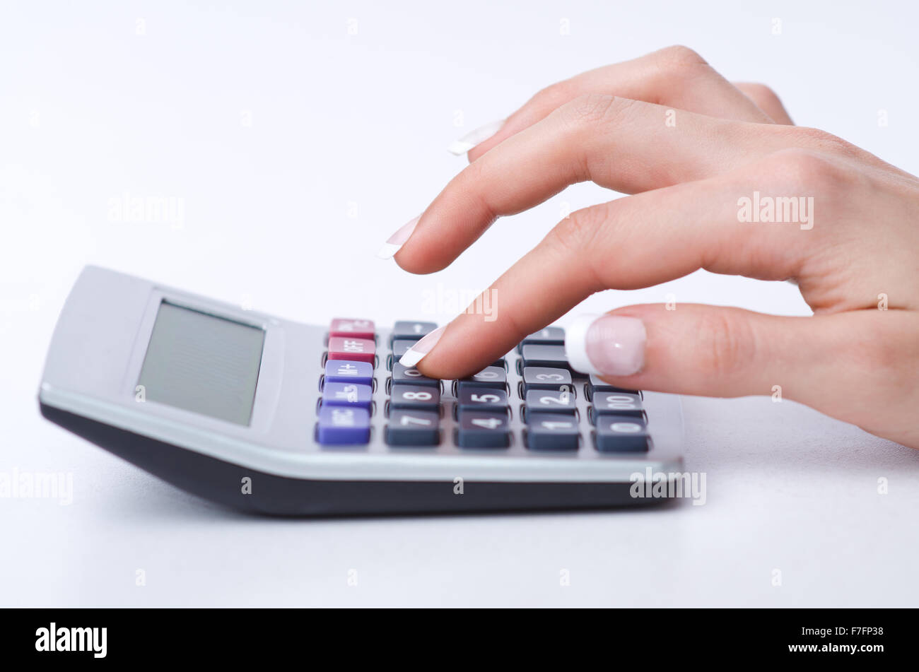Hands working on the calculator Stock Photo - Alamy