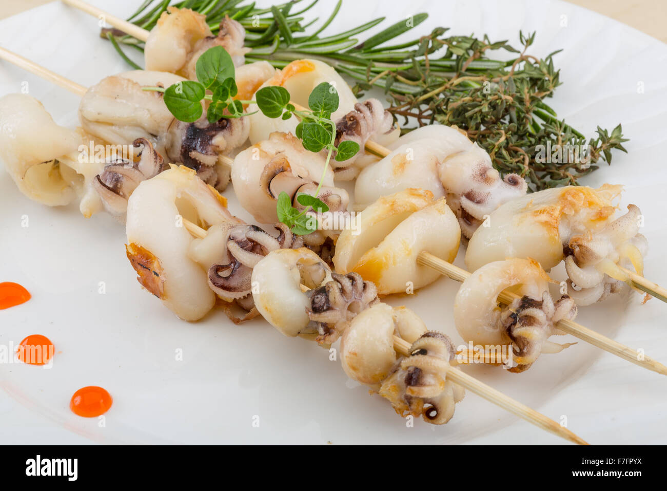 Grilled cuttlefish bbq with rosemary and pepper Stock Photo - Alamy