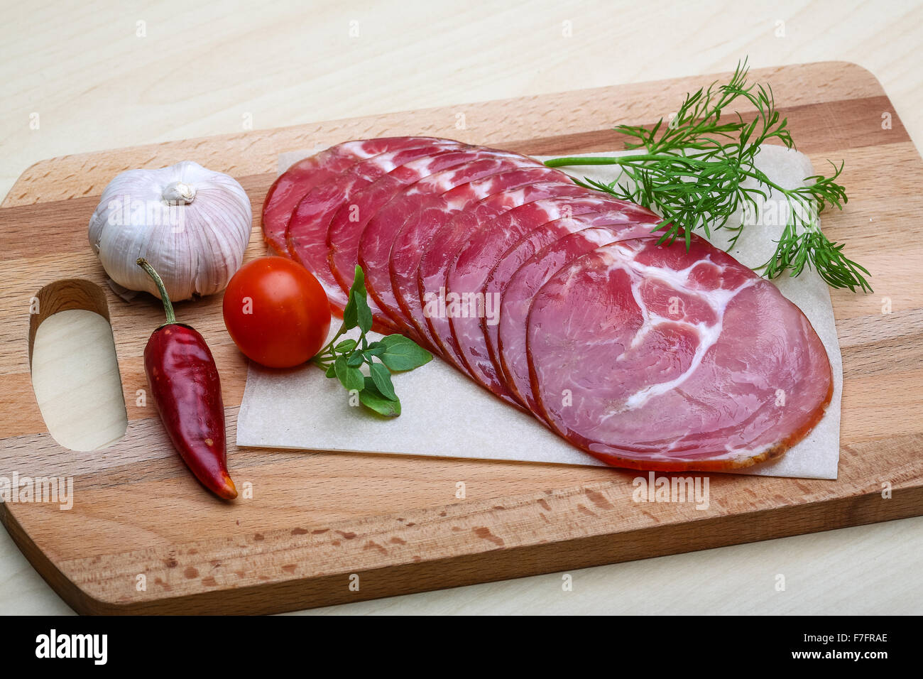 Sliced Ham with herbs on the wood background Stock Photo - Alamy