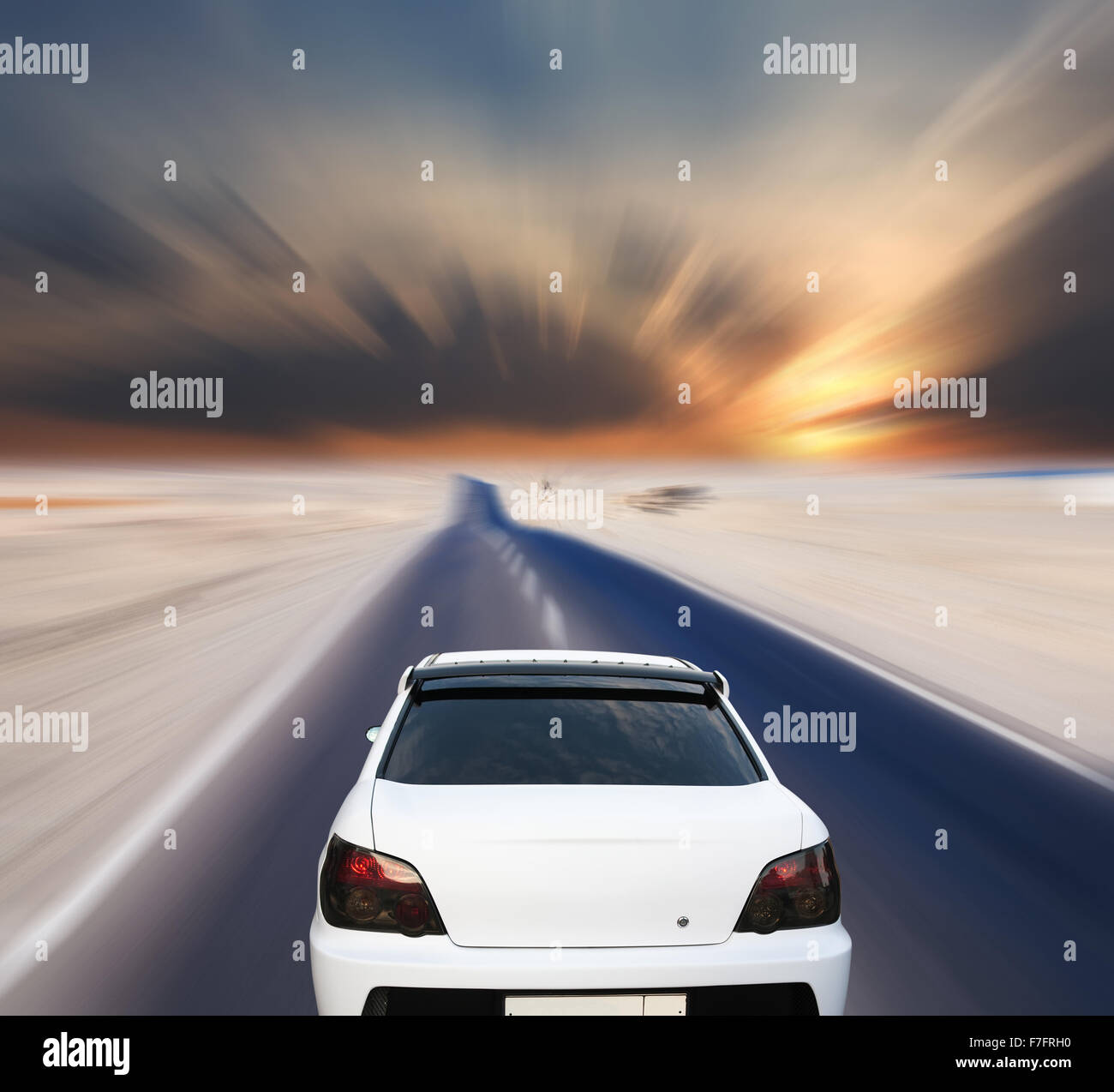White car on desert road under sunset sky Stock Photo - Alamy